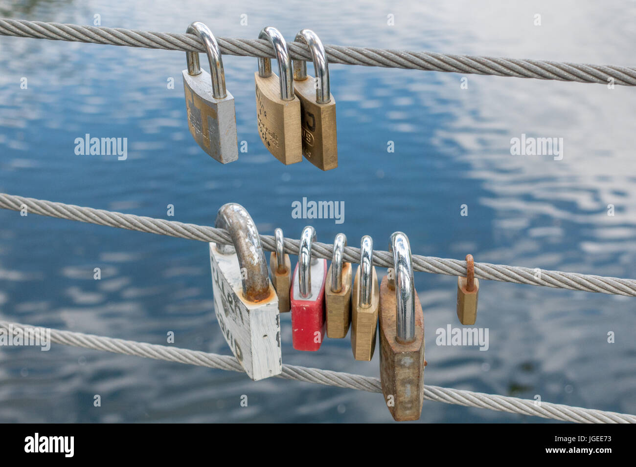 Padlocks on the side of a bridge, safety wires Stock Photo - Alamy