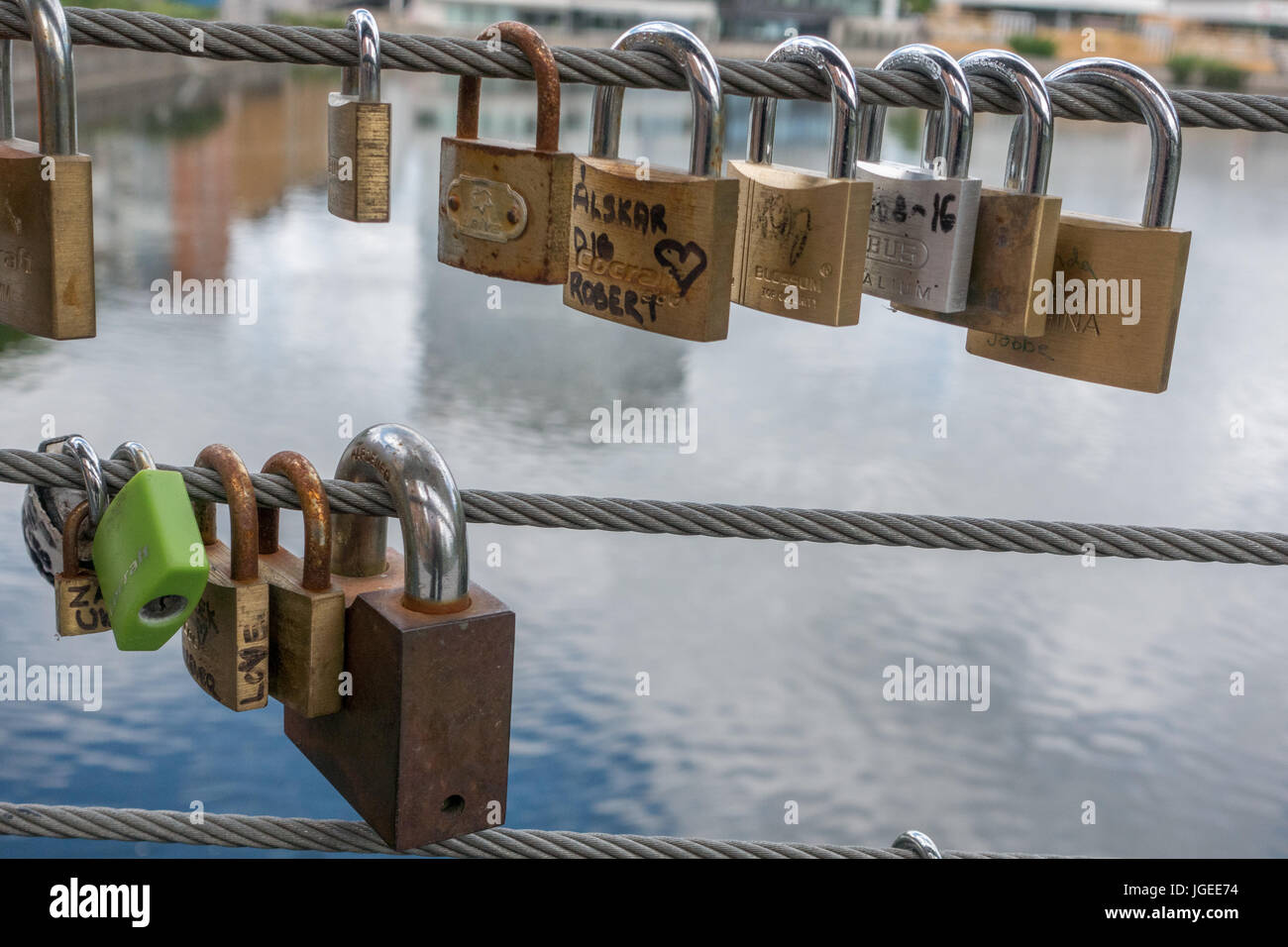 Padlocks on the side of a bridge, safety wires Stock Photo - Alamy