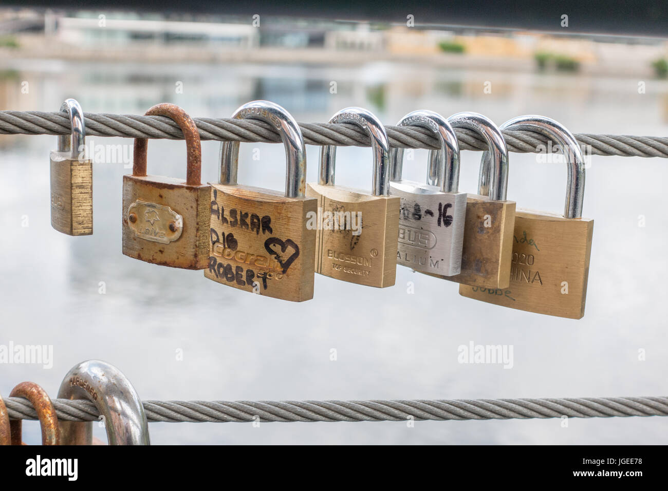 Padlocks on the side of a bridge, safety wires Stock Photo - Alamy