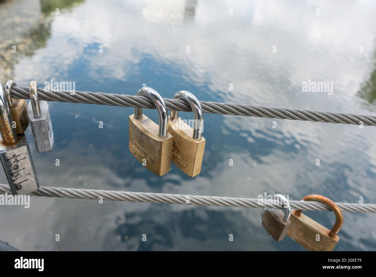 Padlocks on the side of a bridge, safety wires Stock Photo - Alamy
