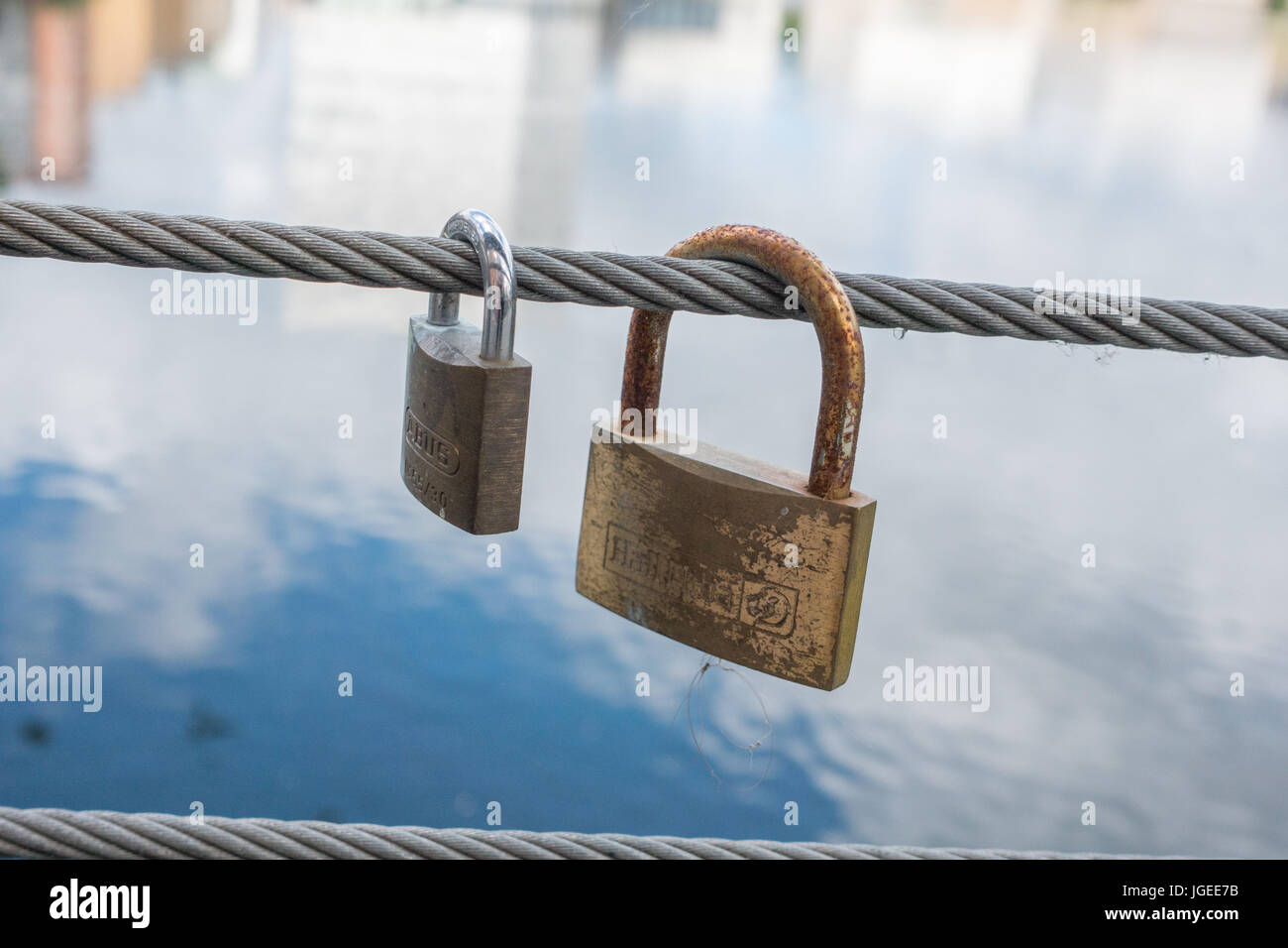 Padlocks on the side of a bridge, safety wires Stock Photo - Alamy