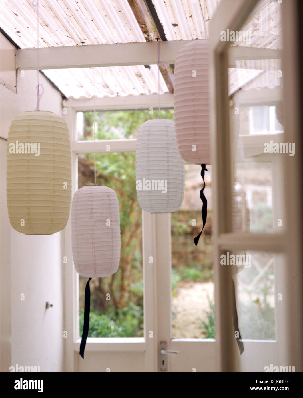 Chinese style paper lanterns in small conservatory Stock Photo - Alamy