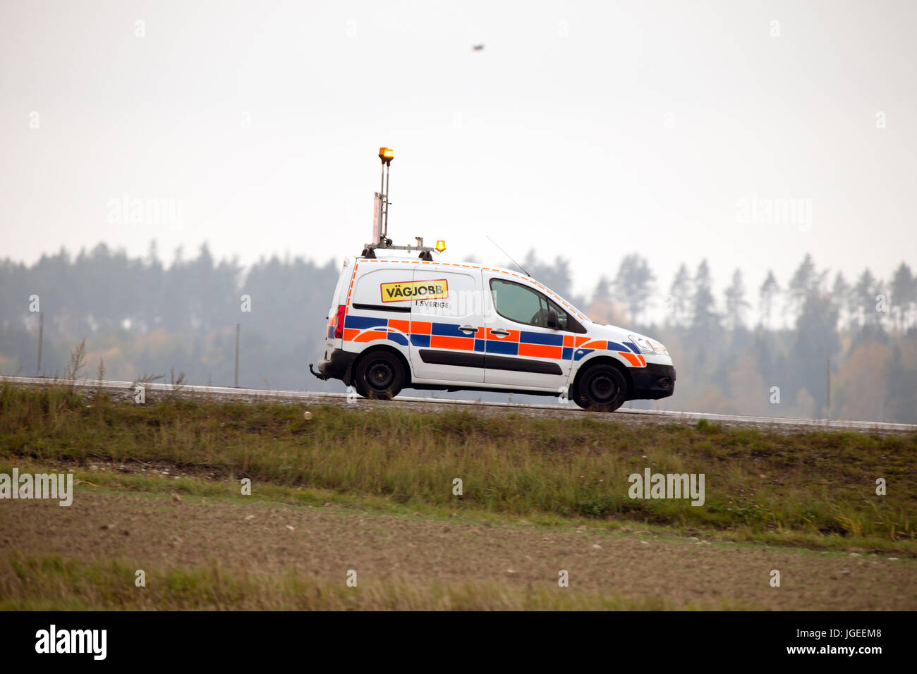 White roaad alert van on a highway Stock Photo - Alamy