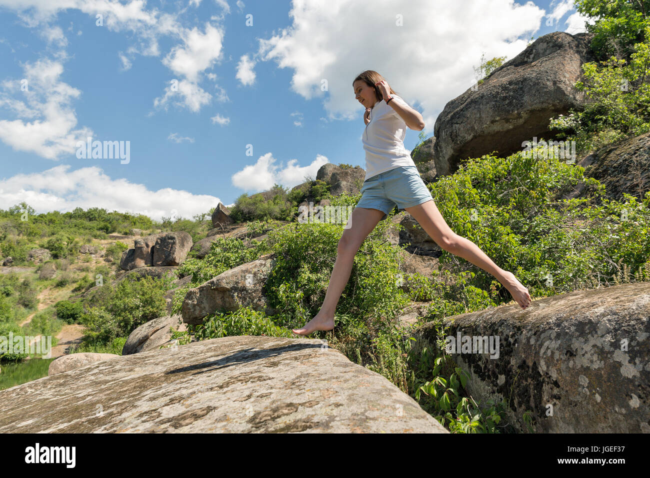 Young caucasian beautiful fitness woman running barefoot at mountain ...