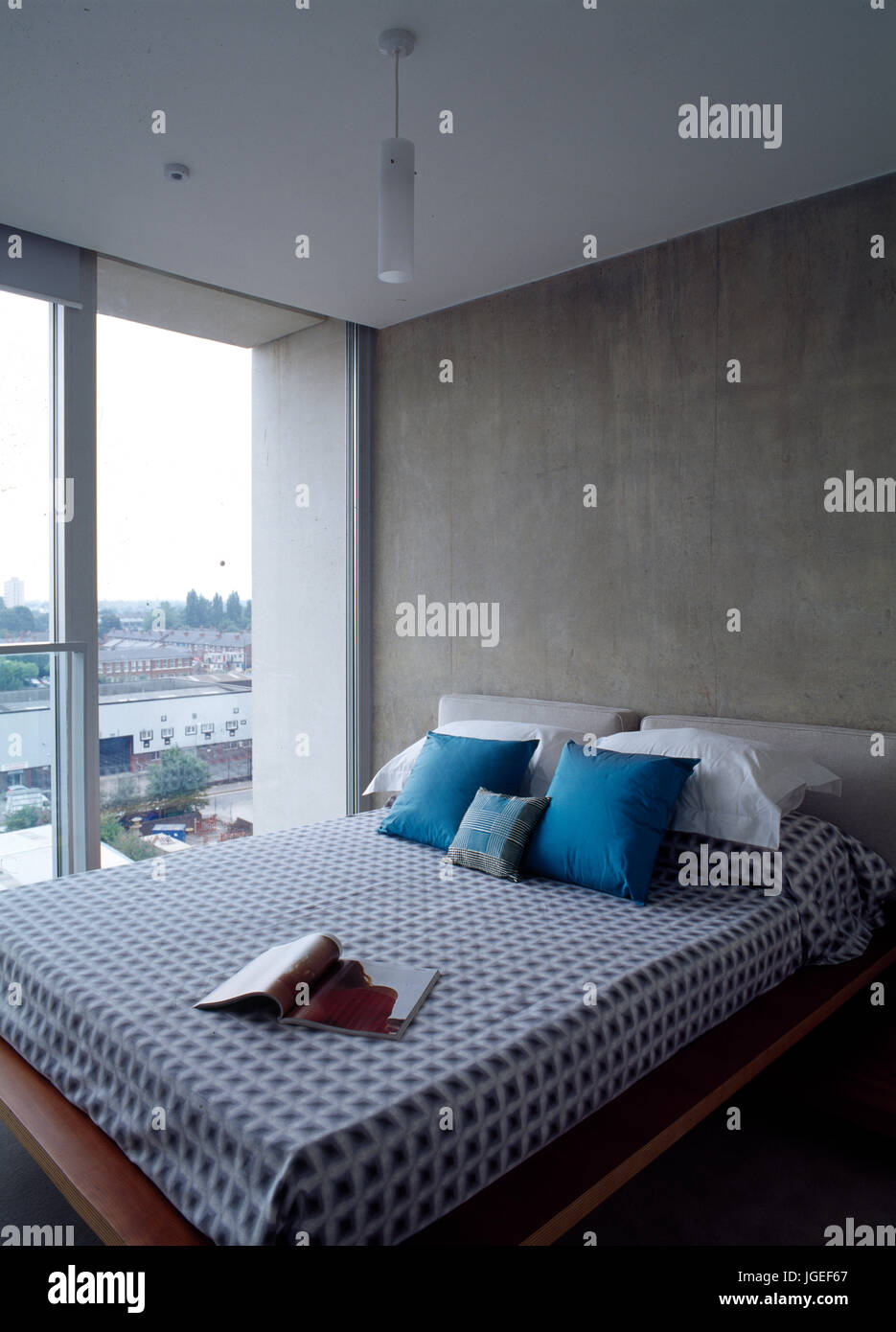 Modern platform bed in front of picture window in a penthouse apartment ...