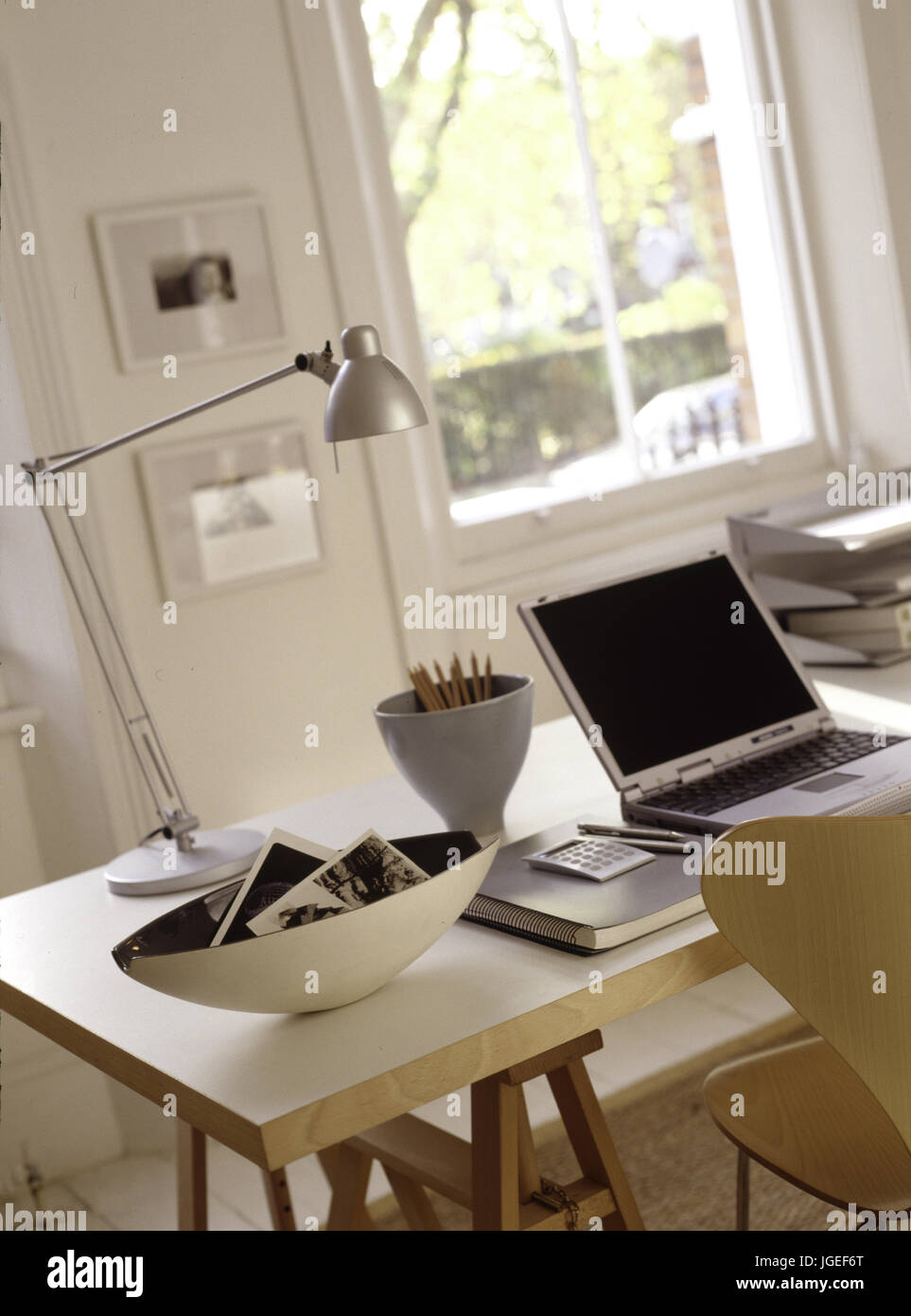 Modern trestle desk with laptop and lAnglepoise style lamp Stock Photo ...