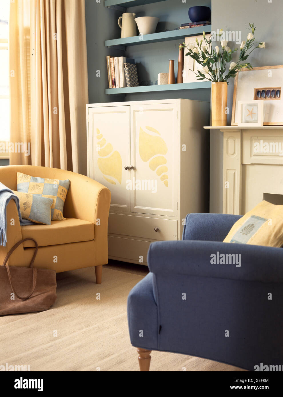 Modern living room with upholstered chairs and shell stenciled cupboard ...