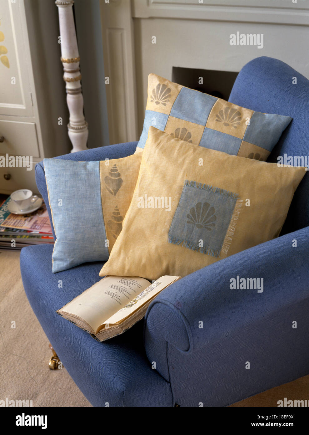 Closeup of blue easy chair, with stenciled and patchork cushions and ...