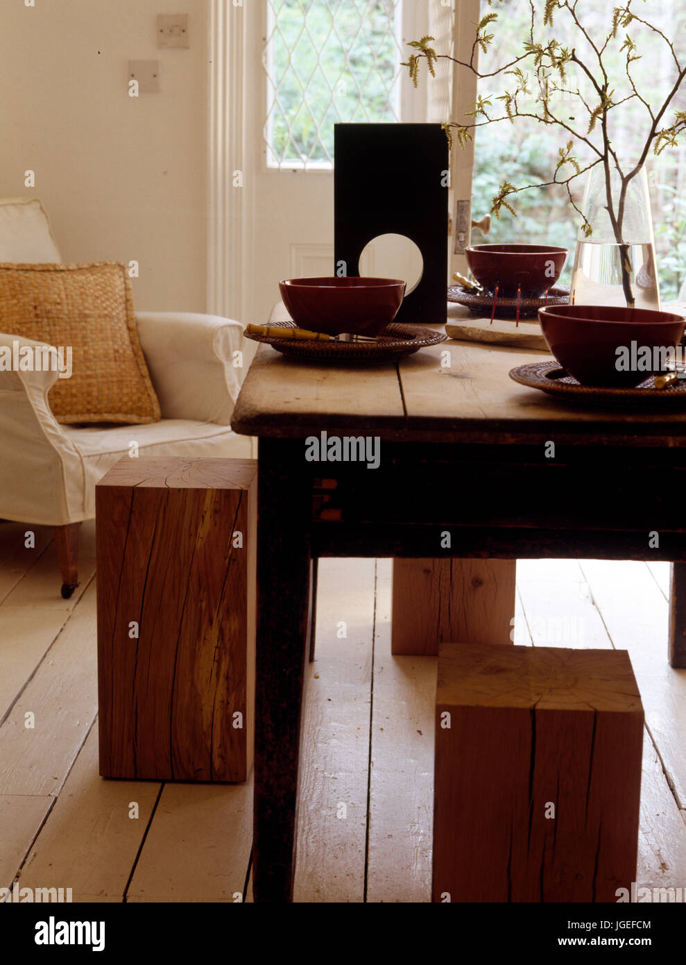 Dining room with wood blocks at wooden table and stripped wooden floor ...