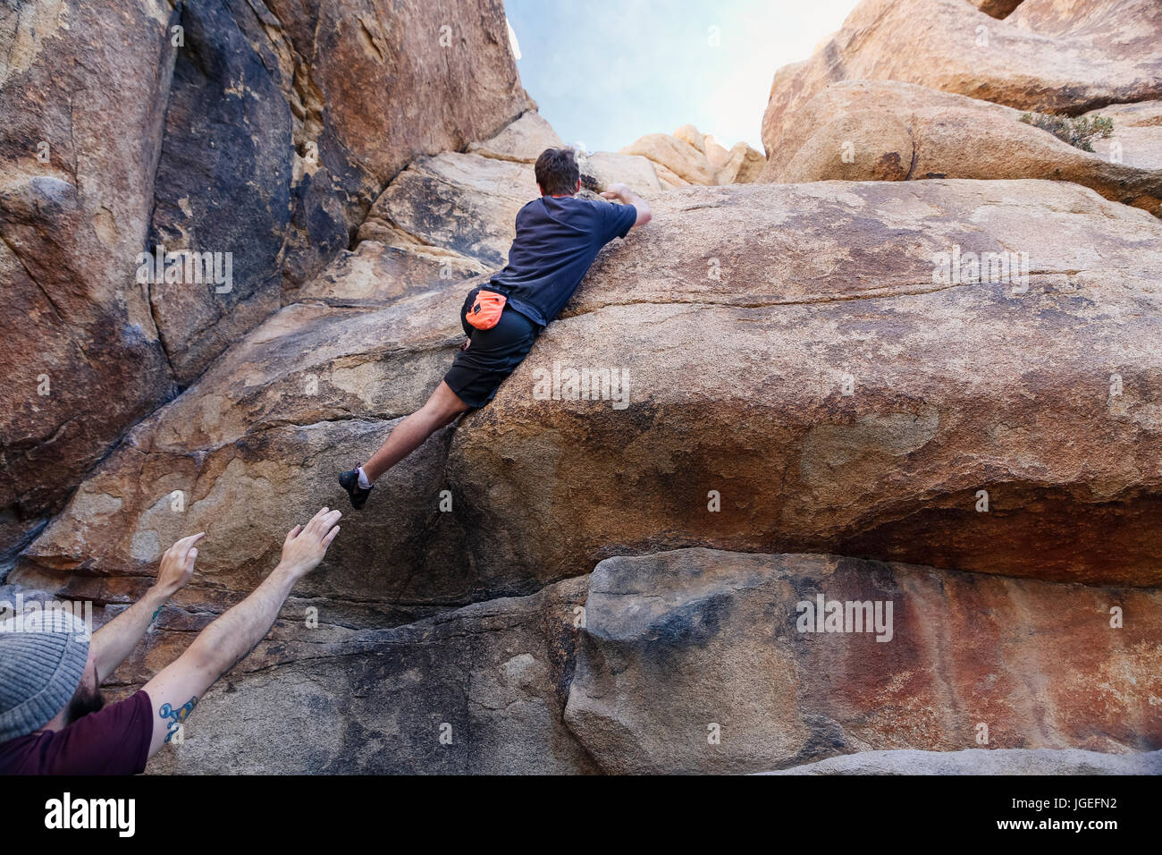 Young caucasian men rock climb in the desert Stock Photo - Alamy