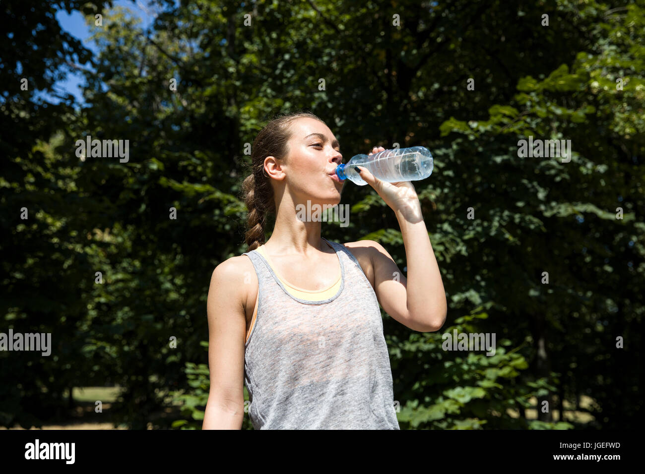 Woman drinking water after training hi-res stock photography and images ...