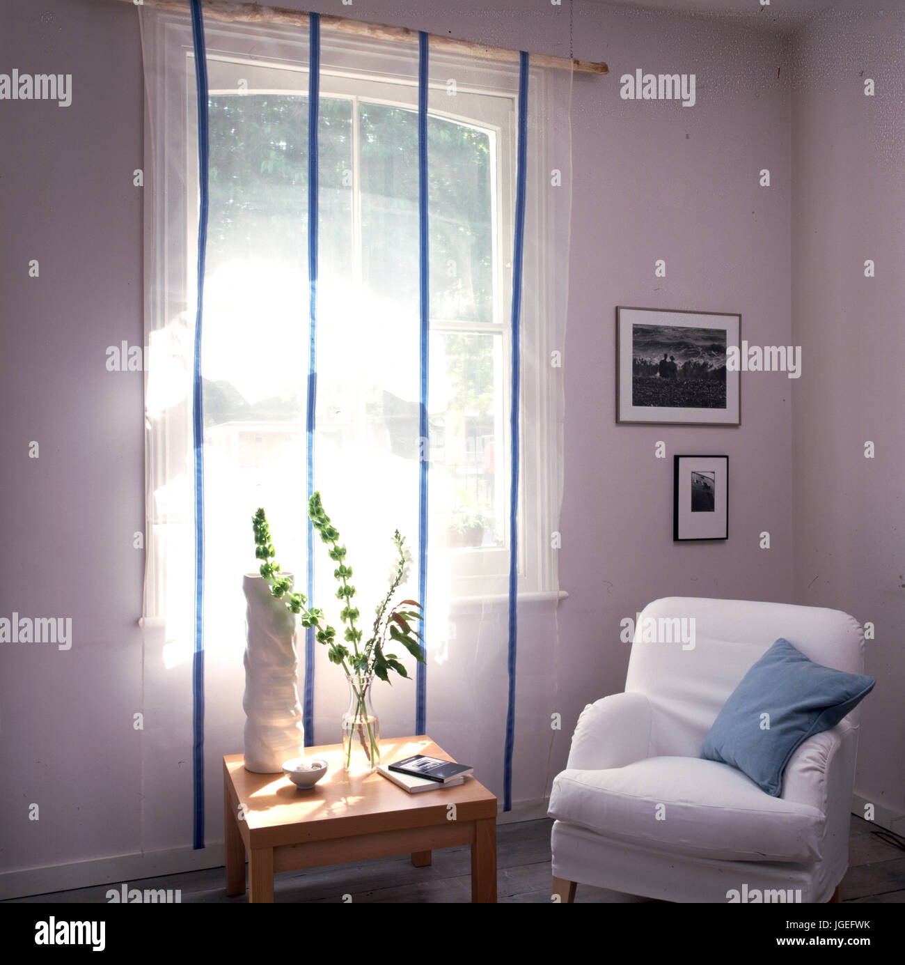 Sheer fabric covering window with blue vertical ribbons Stock Photo - Alamy
