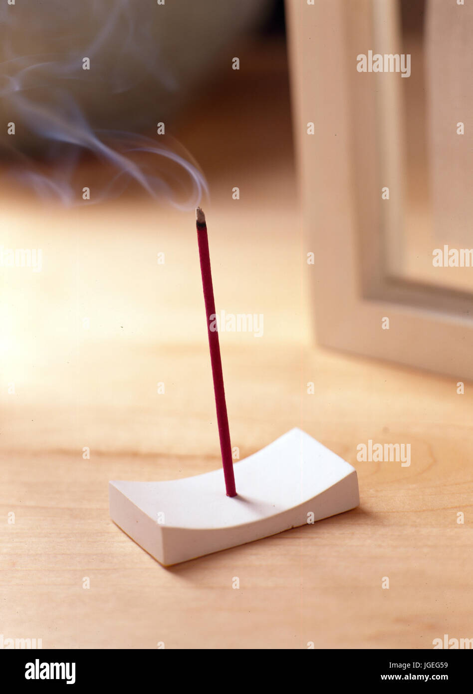 Lighted incense stick in holder Stock Photo - Alamy