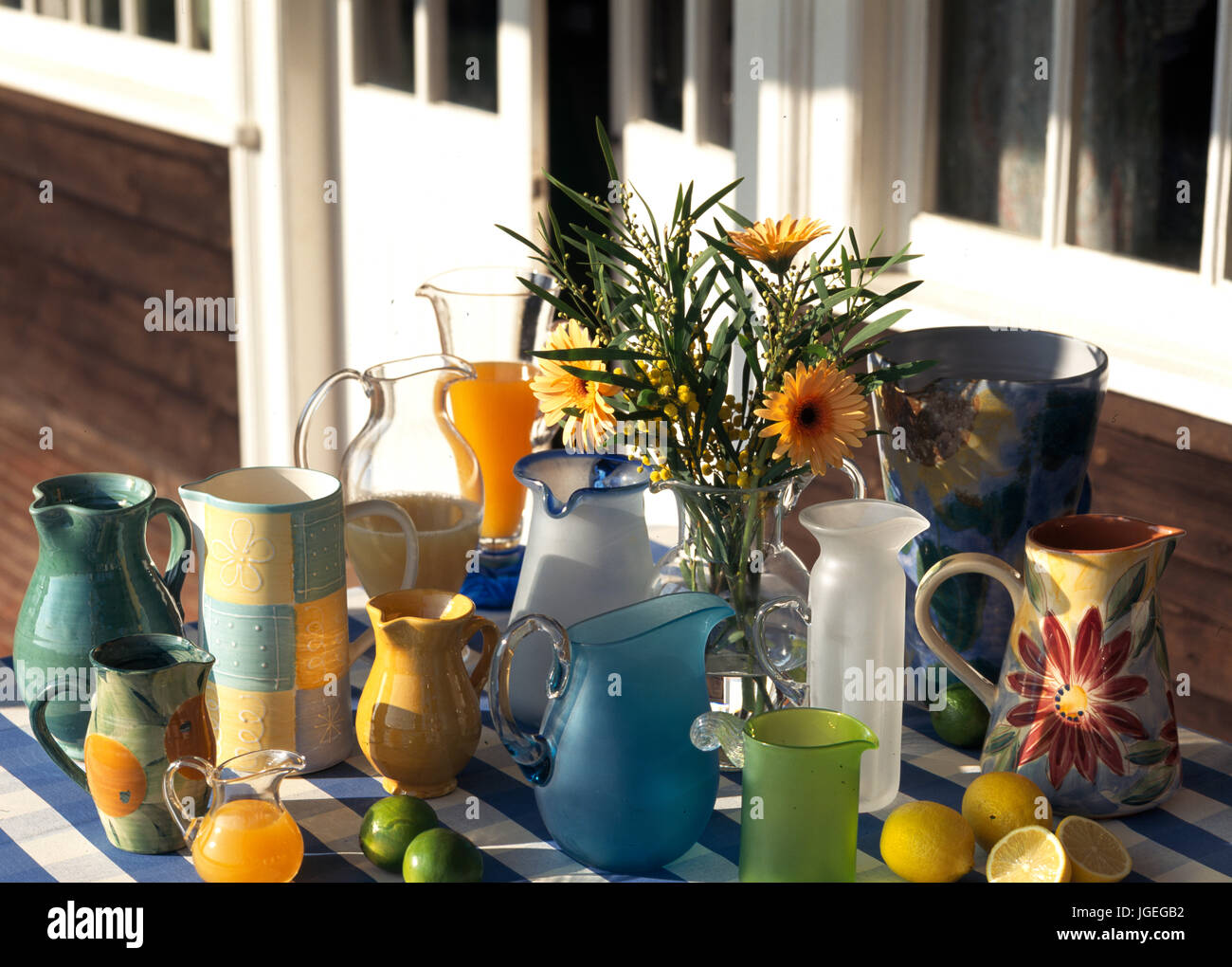 Table with assorted sizes and coloured jugs Stock Photo - Alamy