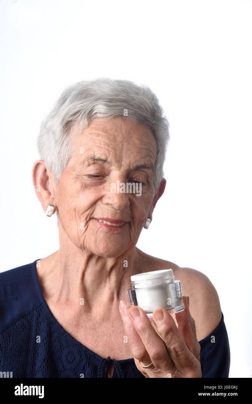 Senior woman applying skin cream or moisturiser to her face Stock Photo ...