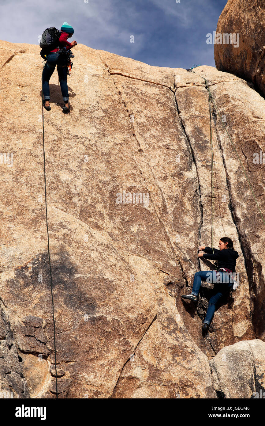 Desert Rock Climbing Two People Climbing Up The Side Of A Large Rock ...
