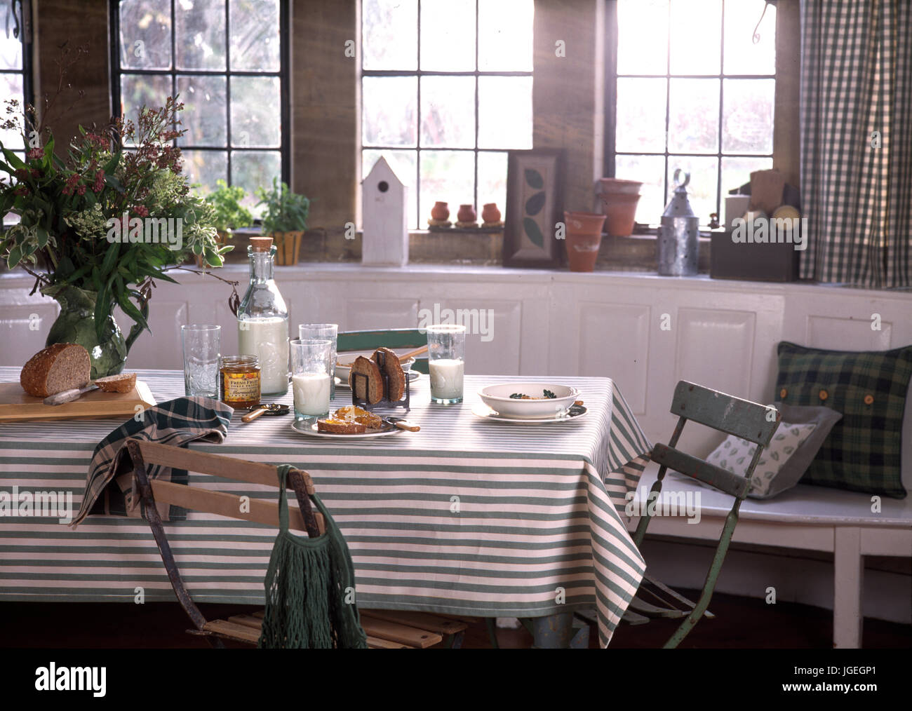 Dining room table set for breakfast with striped cloth Stock Photo - Alamy