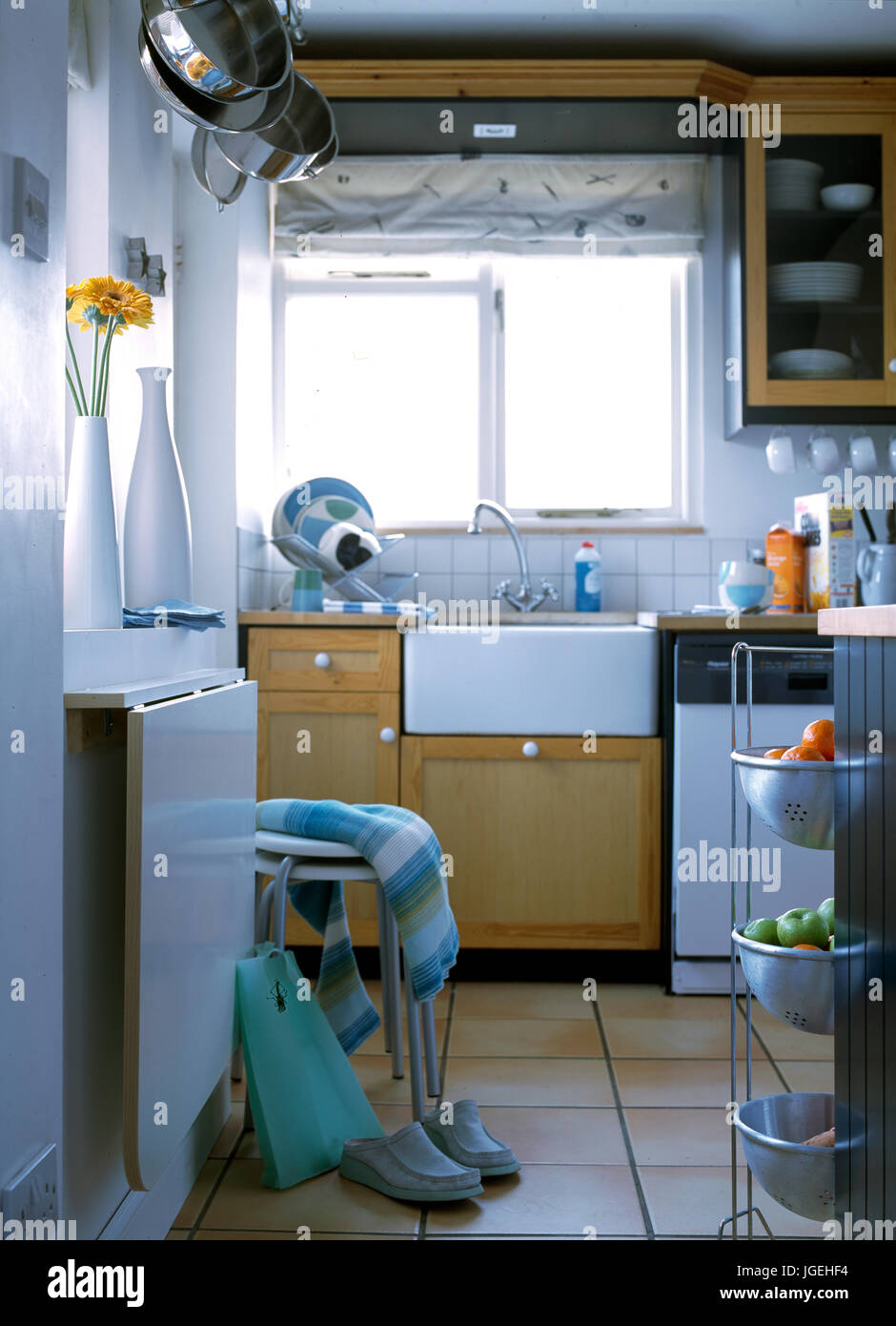 Butler's sink in unit below window in small kitchen Stock Photo - Alamy