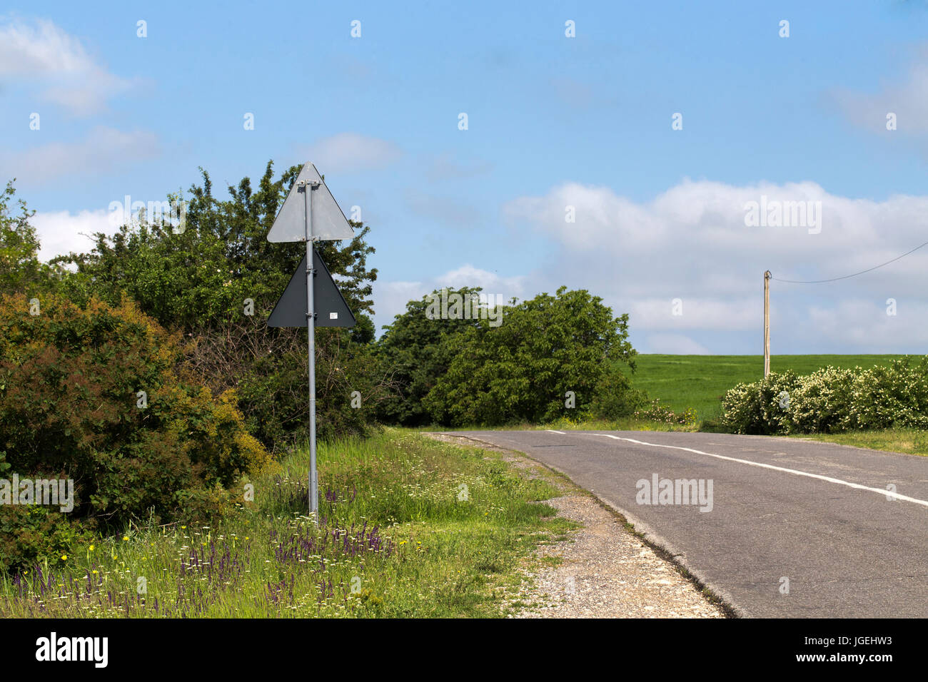Outback road with sign. There are road with sign and blue sky with ...