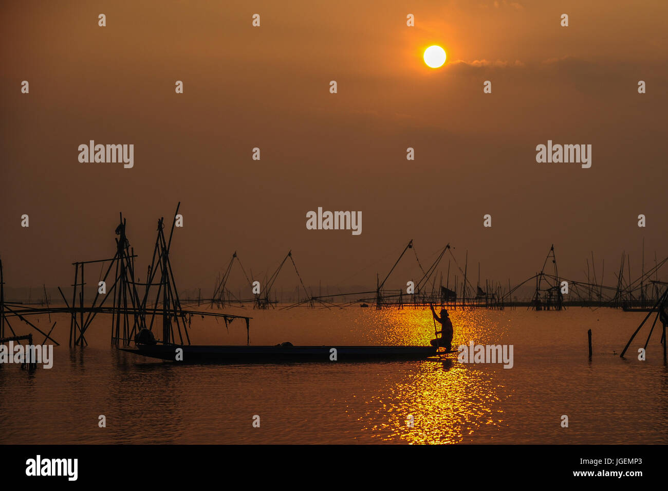 A fisherman going to fish by using the traditional fishing tool ...