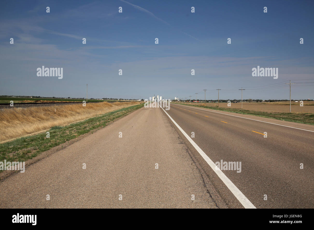 long stright road looking towards the grain silos of syracuse kansas ...