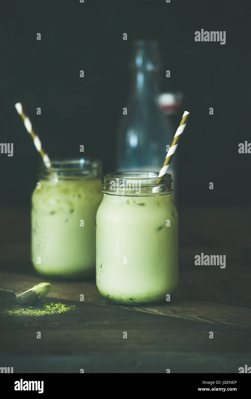 Refreshing iced coconut matcha latte drink in jars, wooden table Stock ...