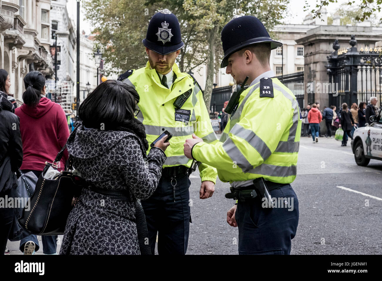 Two police men helping a lady on a street in London, United Kingdom ...