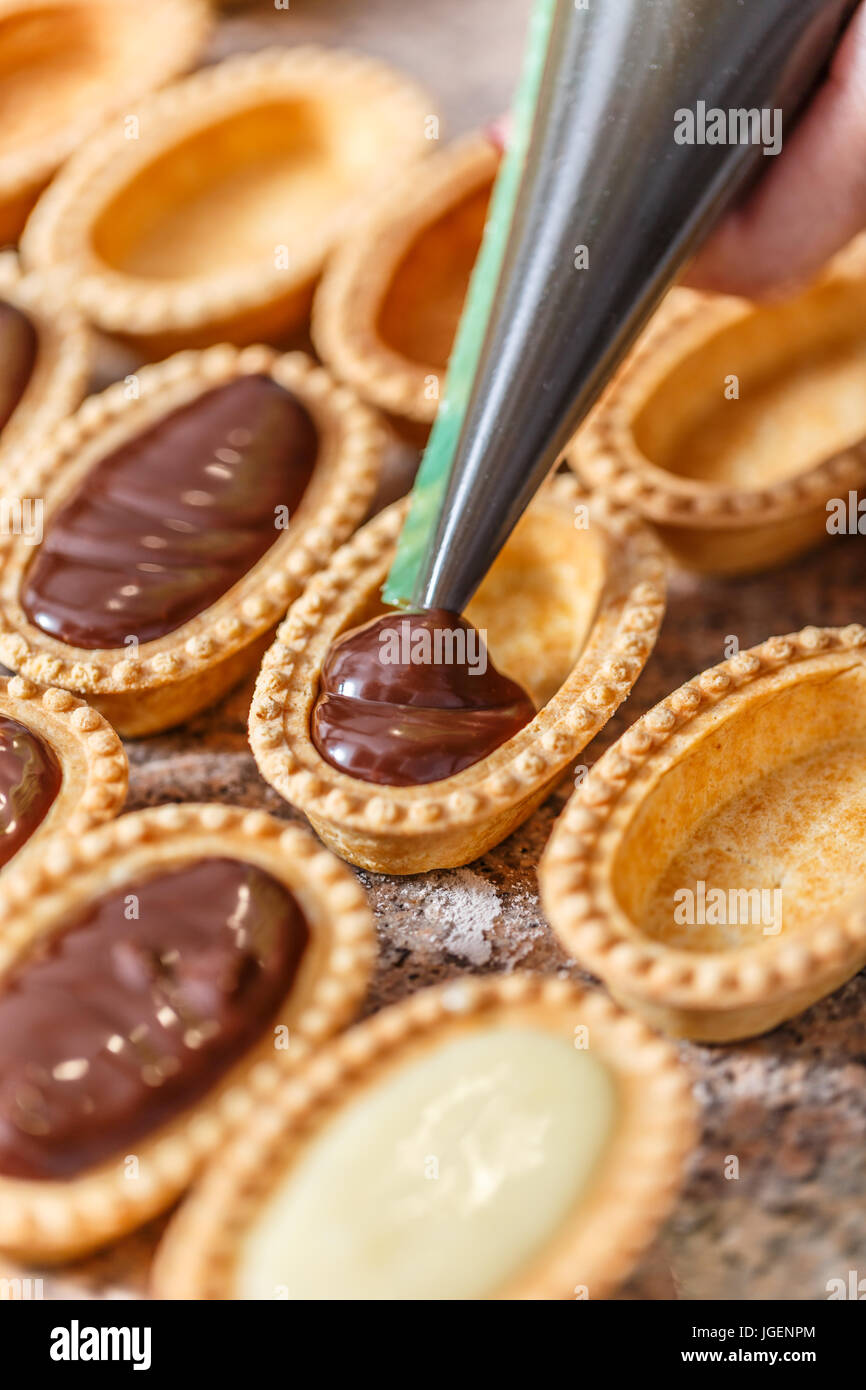 Mini tartlet shells fill with chocolate cream Stock Photo - Alamy