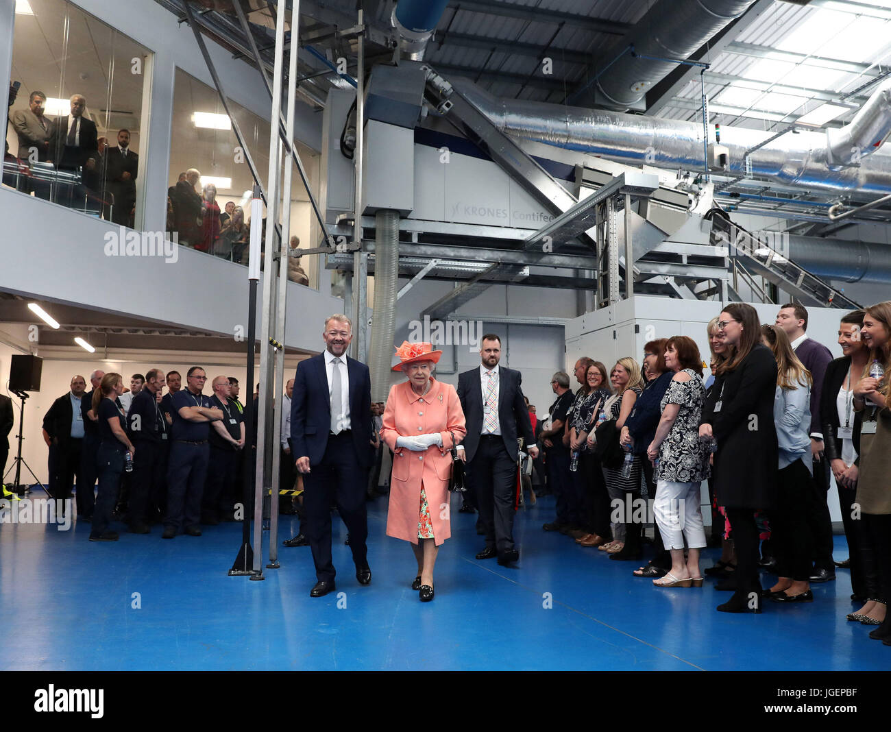Queen Elizabeth II is shown the new bottling plant by Chief Executive ...