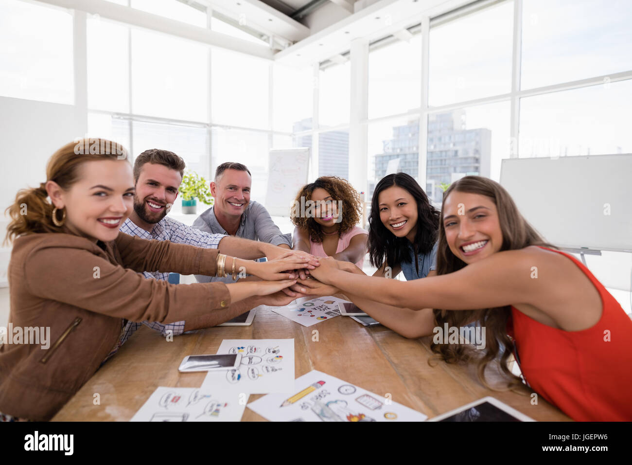 Portrait of team of executives forming hand stack in the office Stock ...