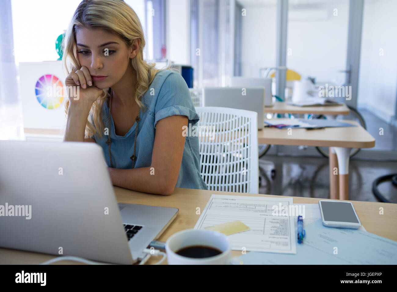 Stressed female executive working at her desk in office Stock Photo - Alamy