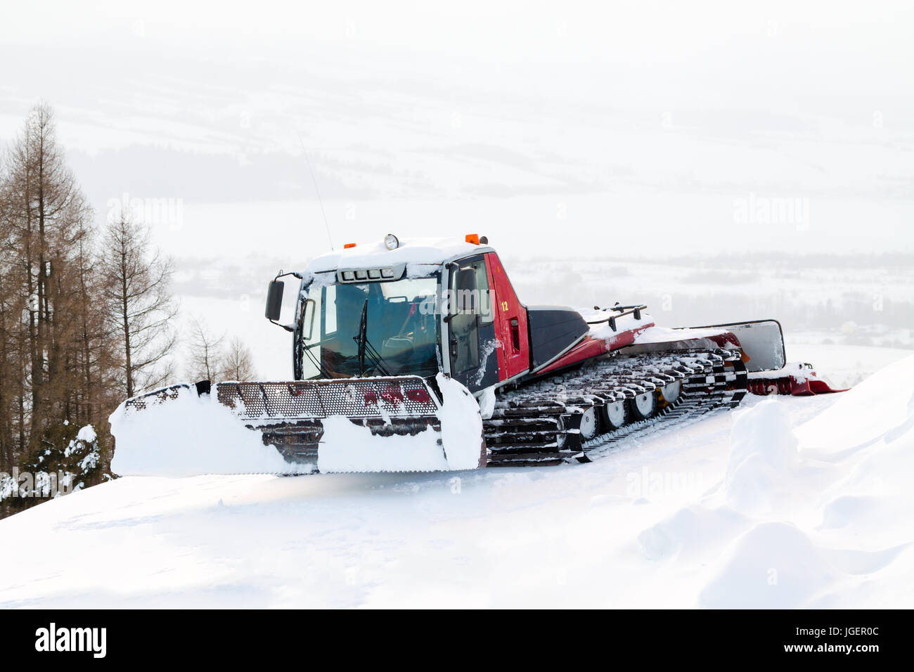 Red winter ratrak parked in slope in the snow Stock Photo - Alamy