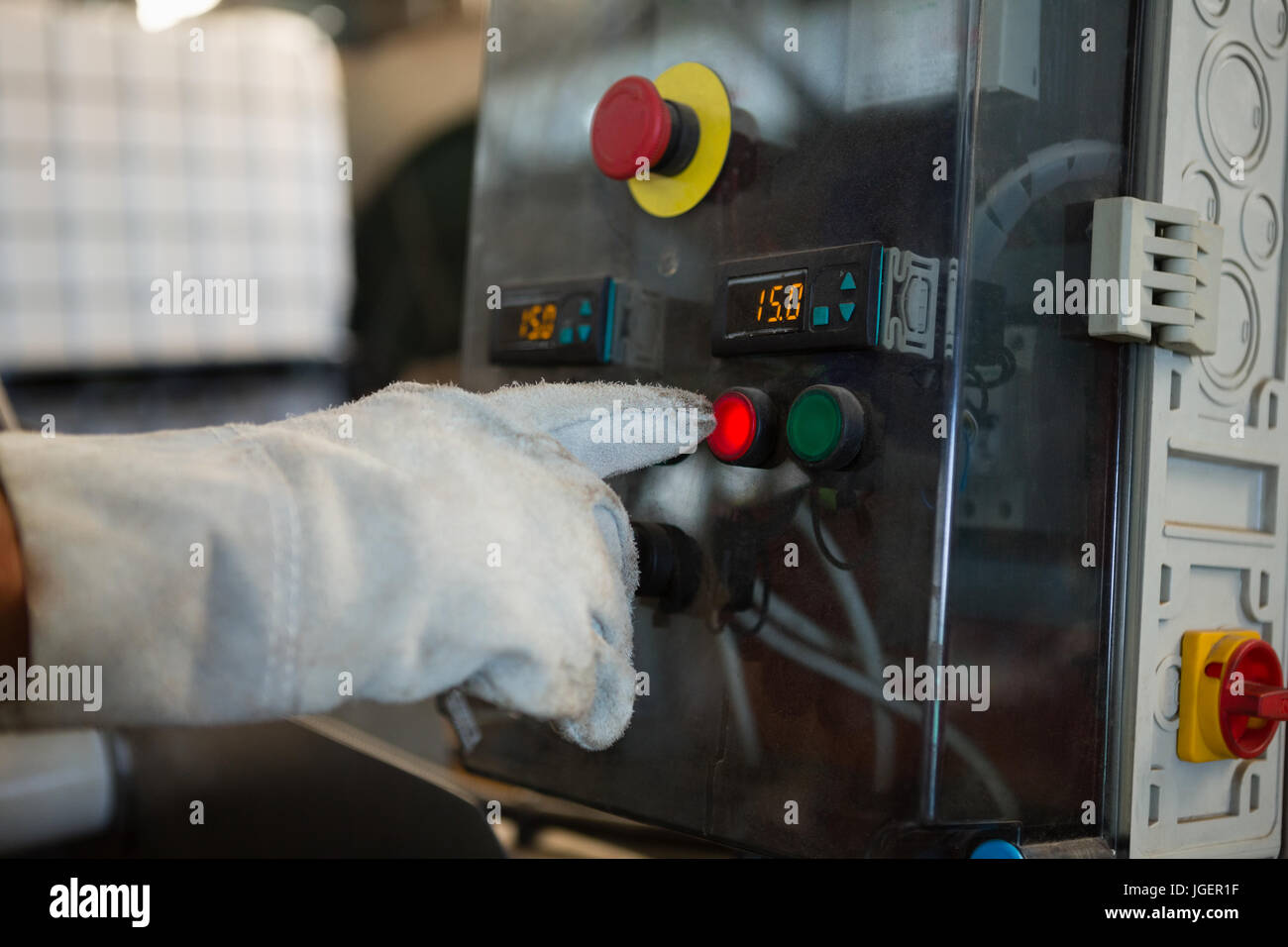 Hand pressing a control button in factory Stock Photo - Alamy