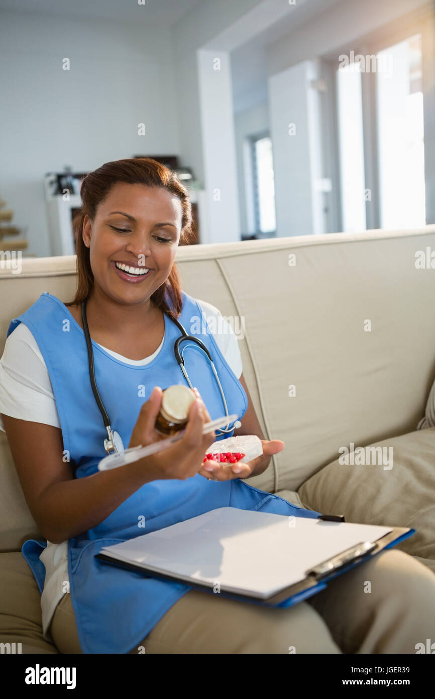 Doctor examining prescription pill bottle in the hospital Stock Photo ...