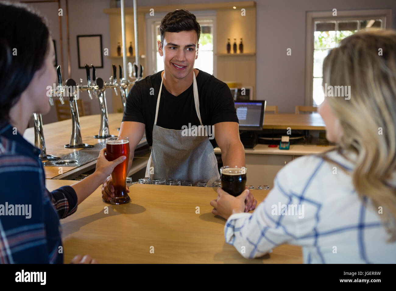 Bartender serving drinks hi-res stock photography and images - Alamy