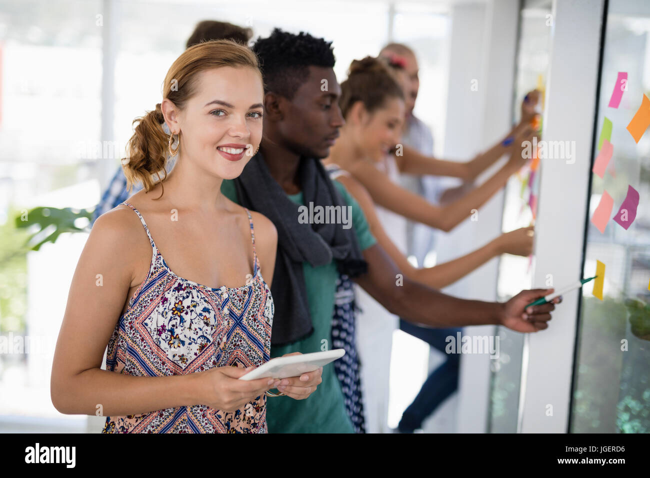 Young female executive using digital tablet in the office Stock Photo ...