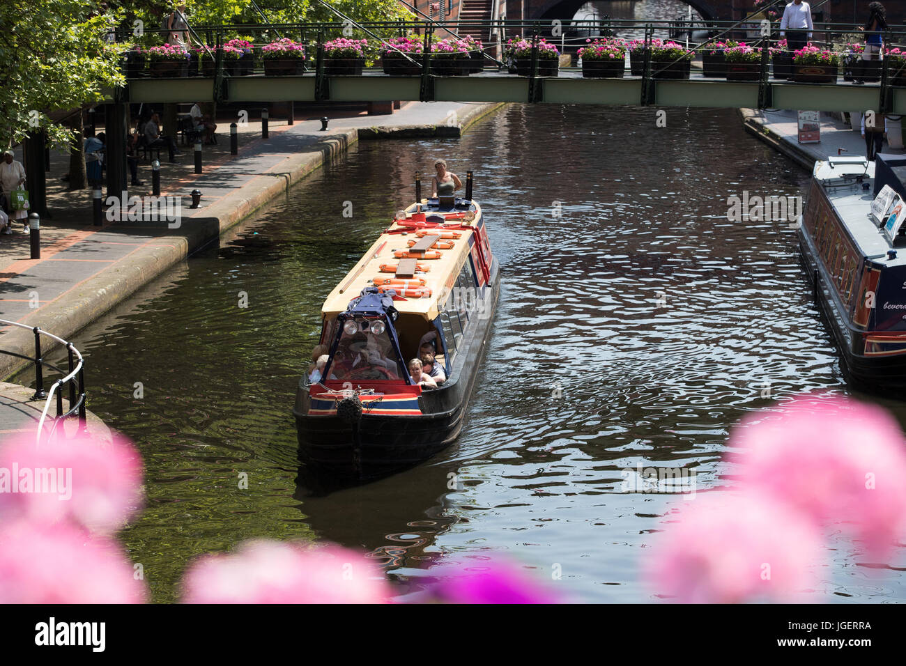 People enjoy the warm weather whilst taking a canal boat tour in ...