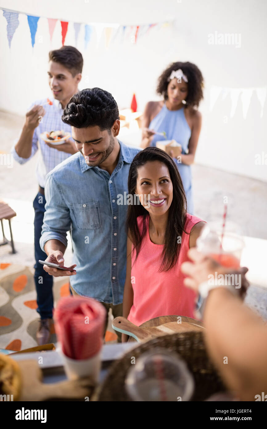Happy customers giving order at food truck counter Stock Photo - Alamy