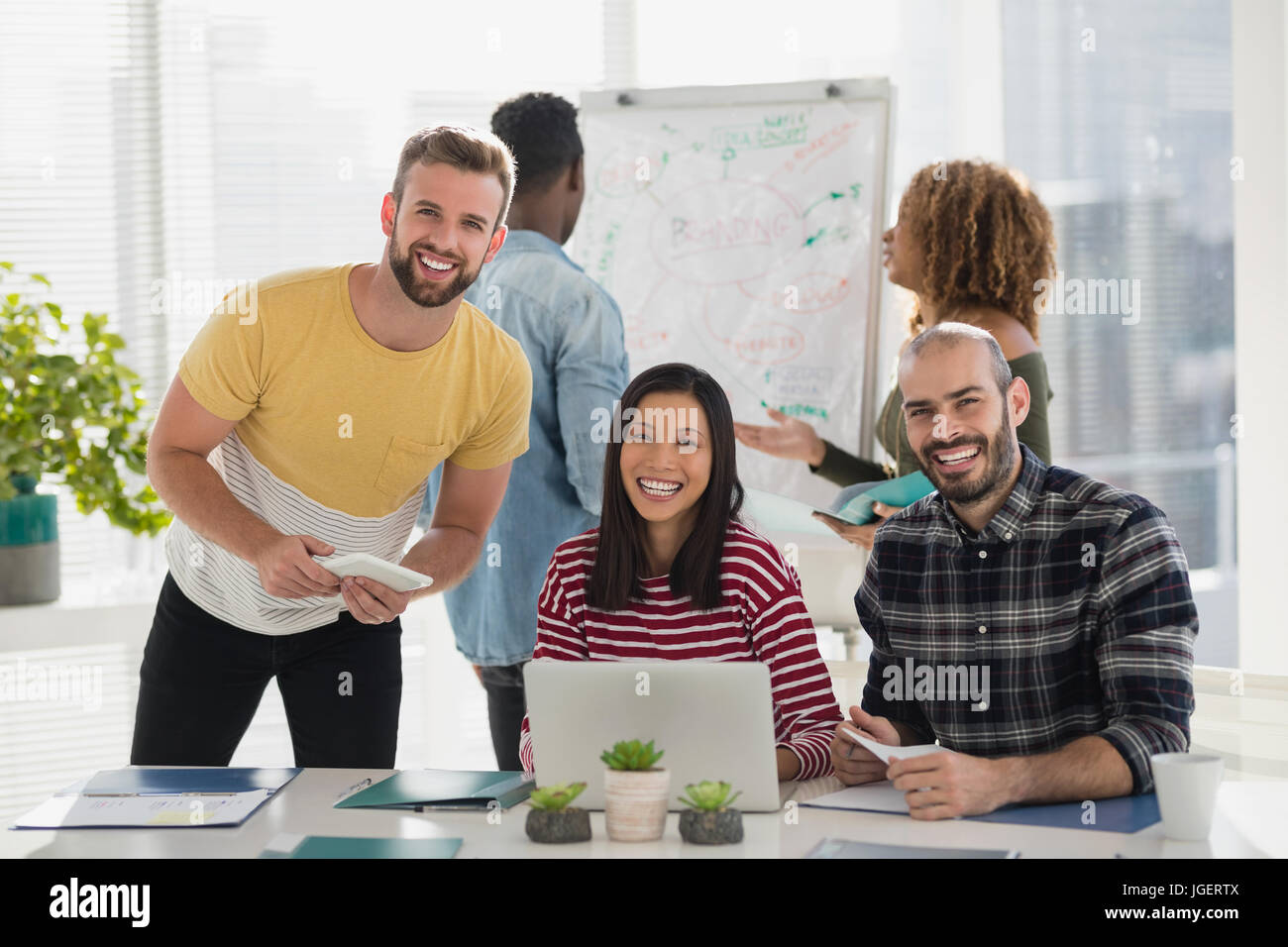 Portrait of team of executives working together in the office Stock ...