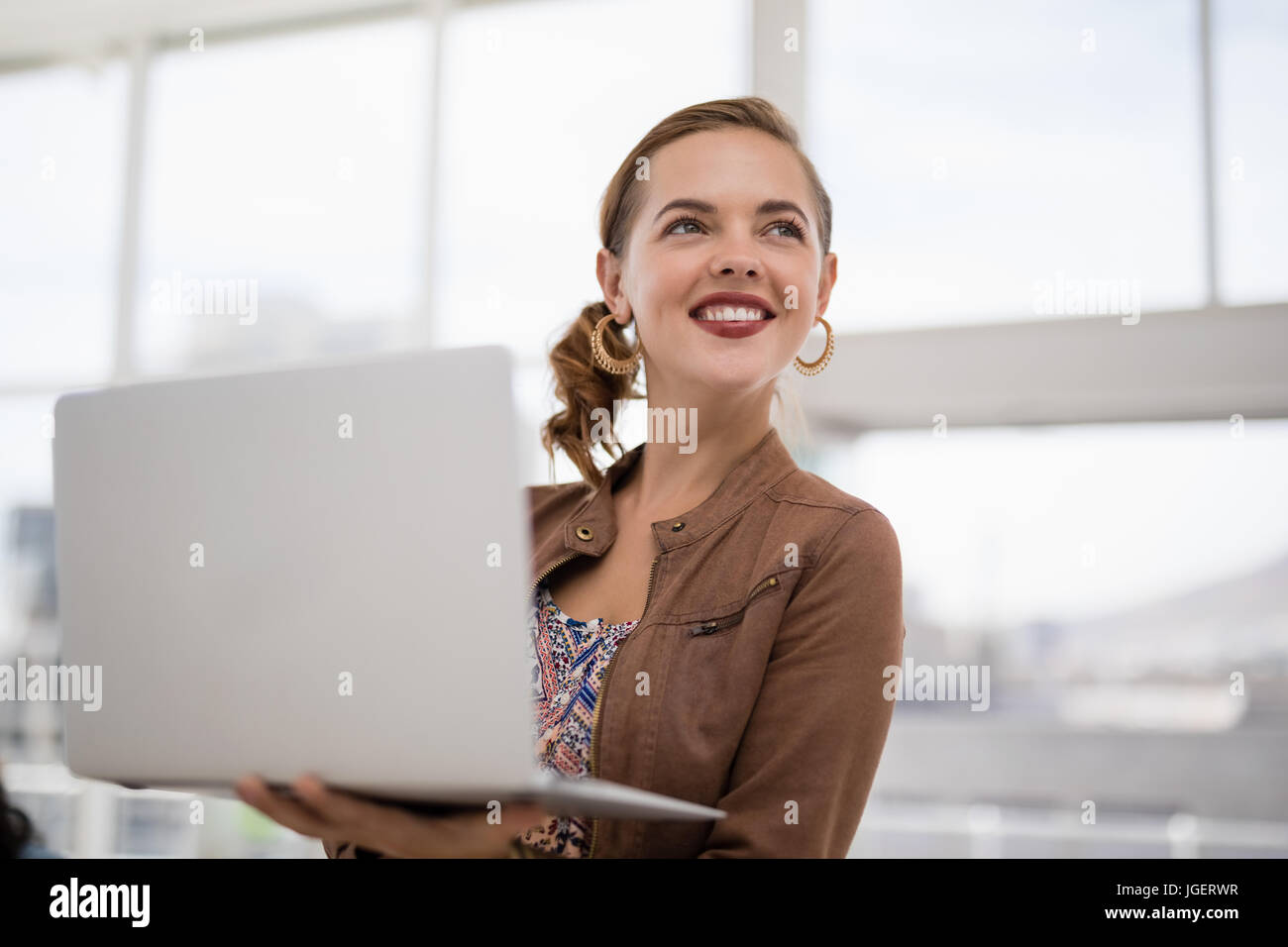 Beautiful female executive working on laptop in the office Stock Photo ...