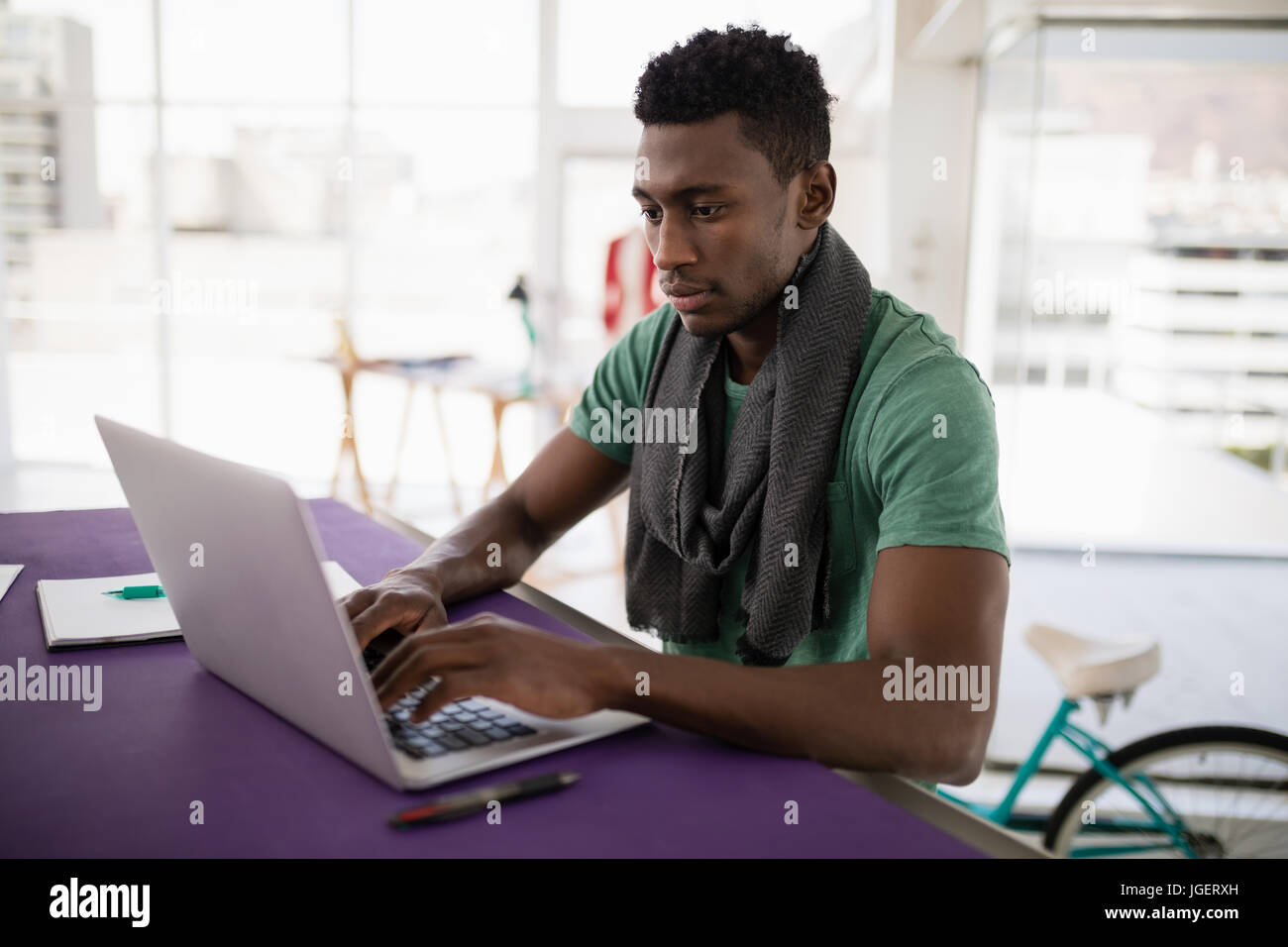 Male executive using laptop at desk in the office Stock Photo - Alamy