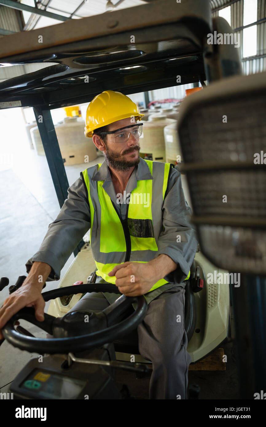 Worker driving a forklift car in factory Stock Photo - Alamy