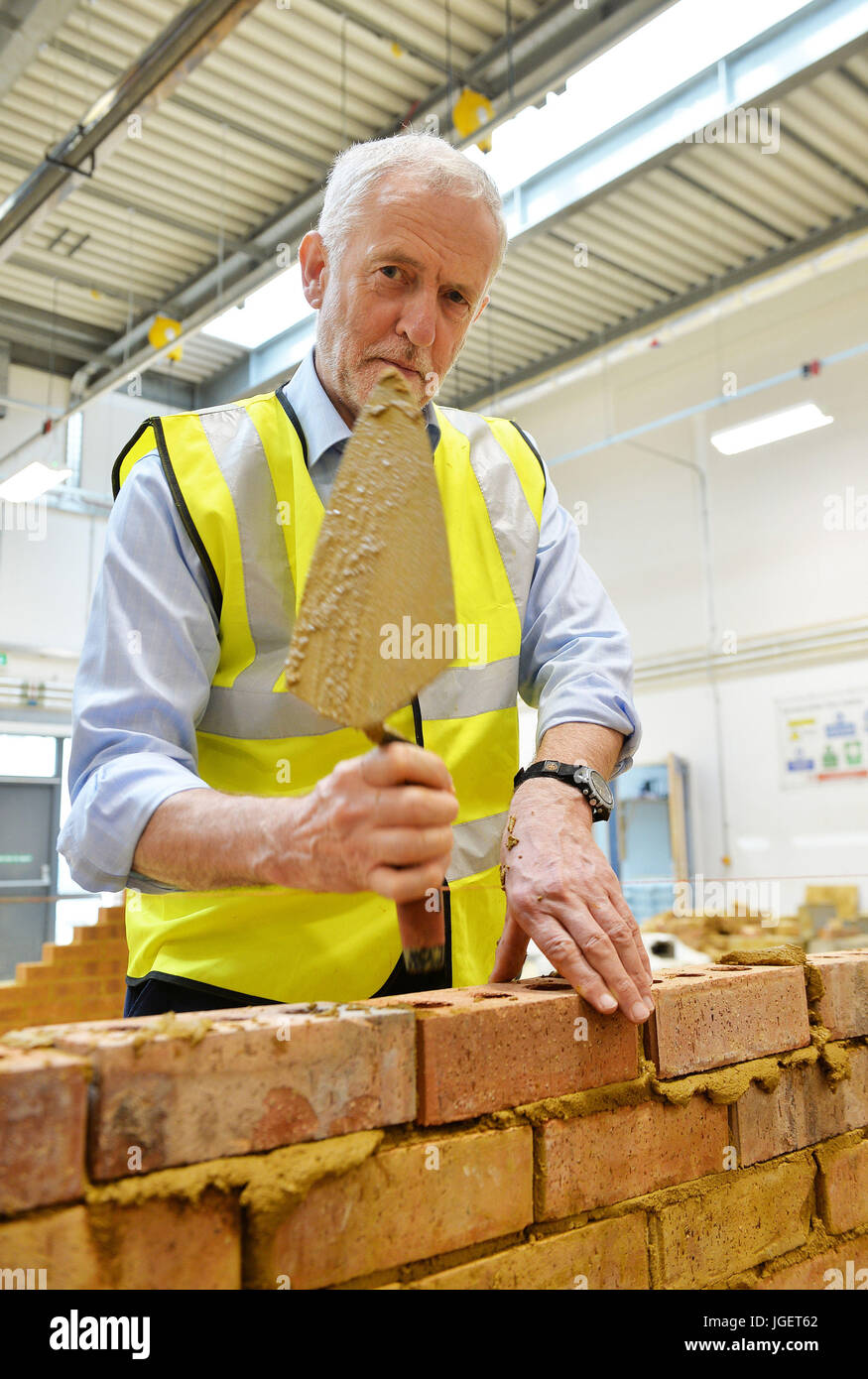 Labour leader Jeremy Corbyn tries his hand at bricklaying during a ...