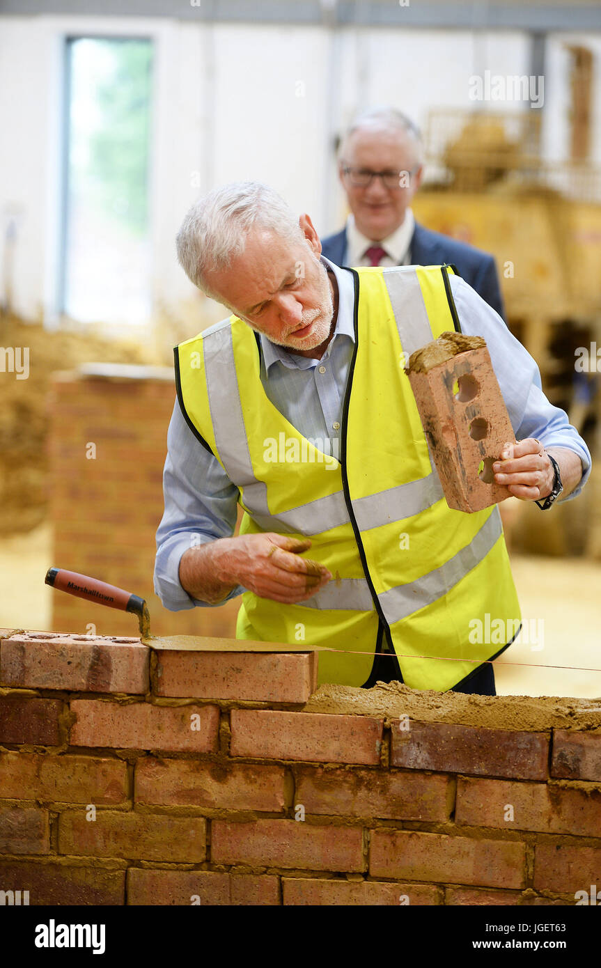 Labour leader Jeremy Corbyn tries his hand at bricklaying during a ...