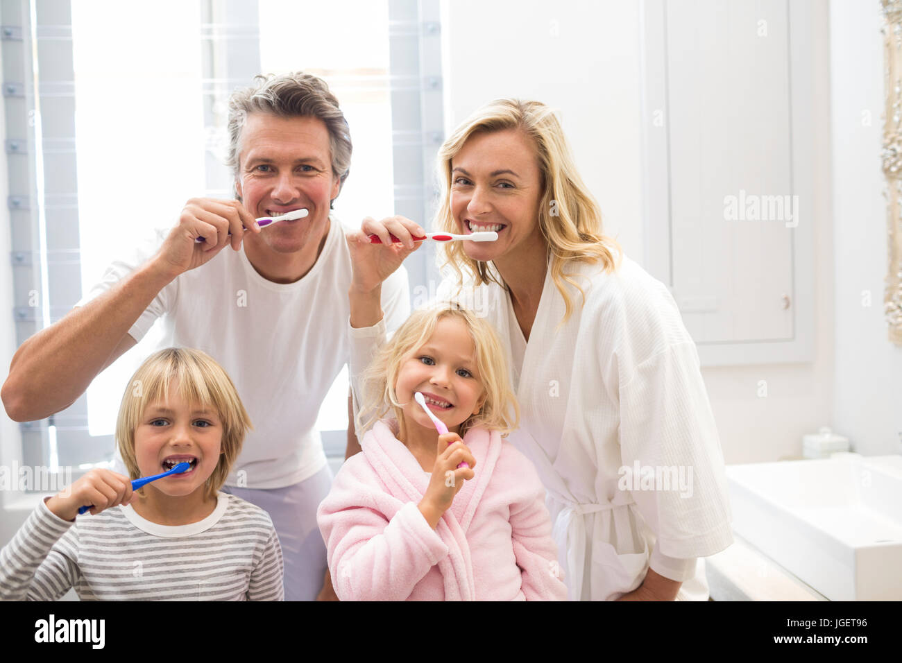 Family brushing teeth together in the bathroom at home Stock Photo - Alamy