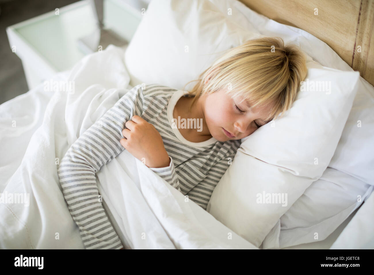 Boy sleeping on bed in the bedroom at home Stock Photo - Alamy