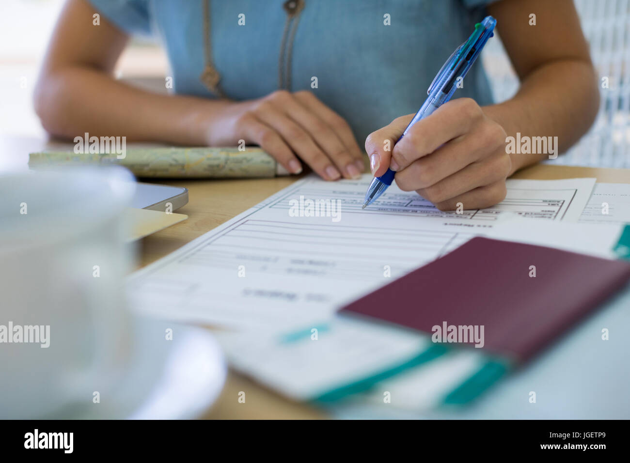 Close-up of female executive filling form at her desk in office Stock ...