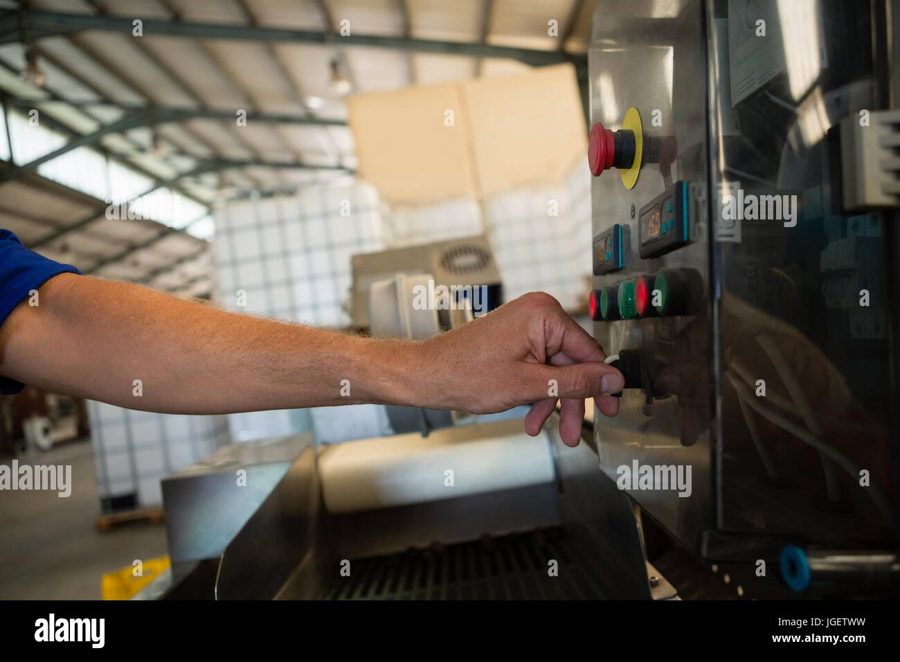 Hand pressing a control button in factory Stock Photo - Alamy