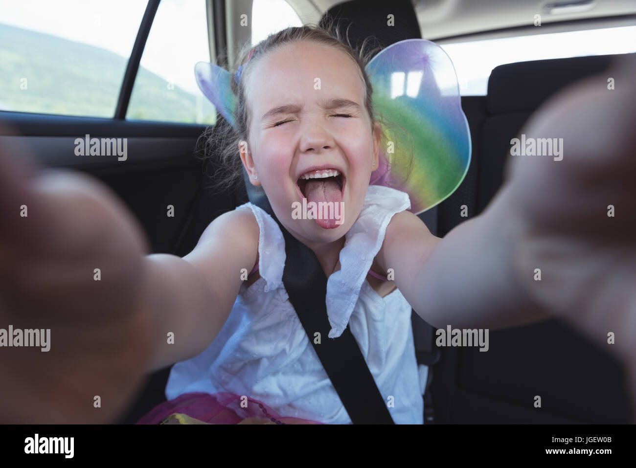 Girl making a facial expression in car Stock Photo - Alamy