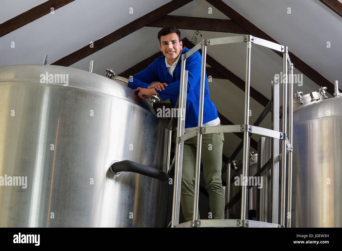 Worker standing ladder tank hi-res stock photography and images - Alamy